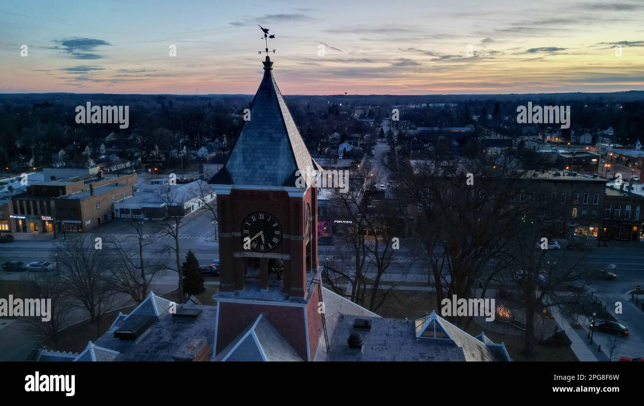 An aerial view of a tall clock tower in the center of a bustling city ...