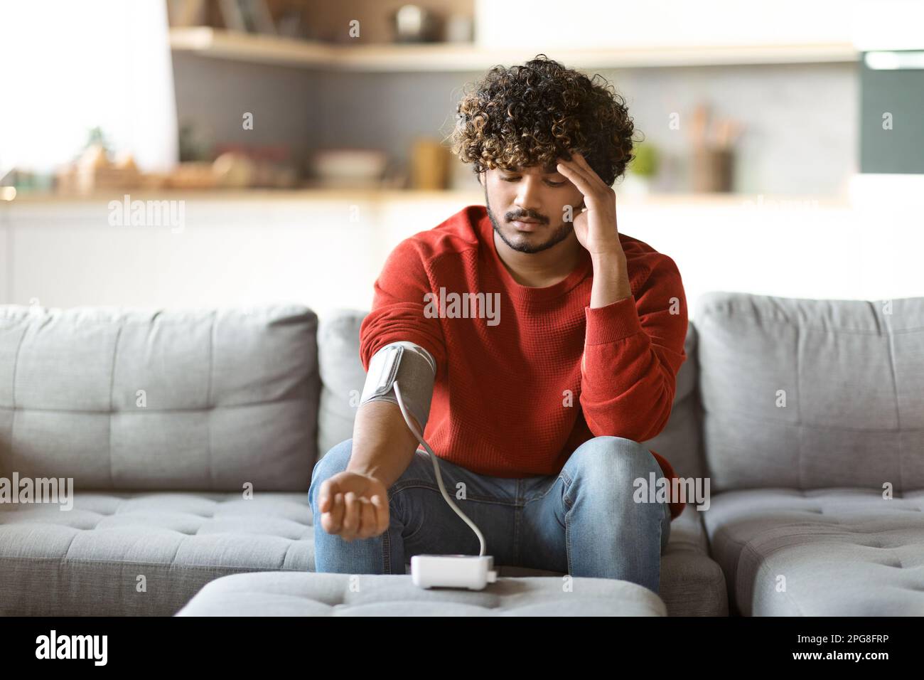 Sick Indian Guy Checking Blood Pressure With Upper Arm Monitor At Home ...
