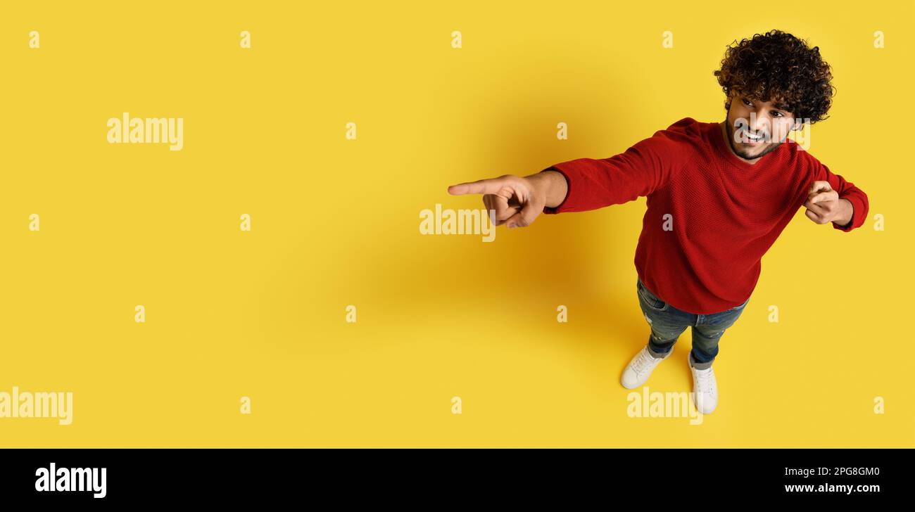 Top view of indian guy pointing at copy space Stock Photo - Alamy