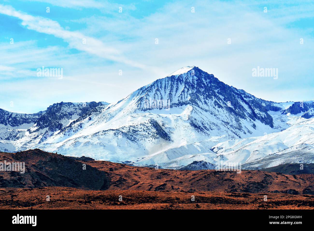Close-up view of the Mount Whitney peak covered with snow against blue ...
