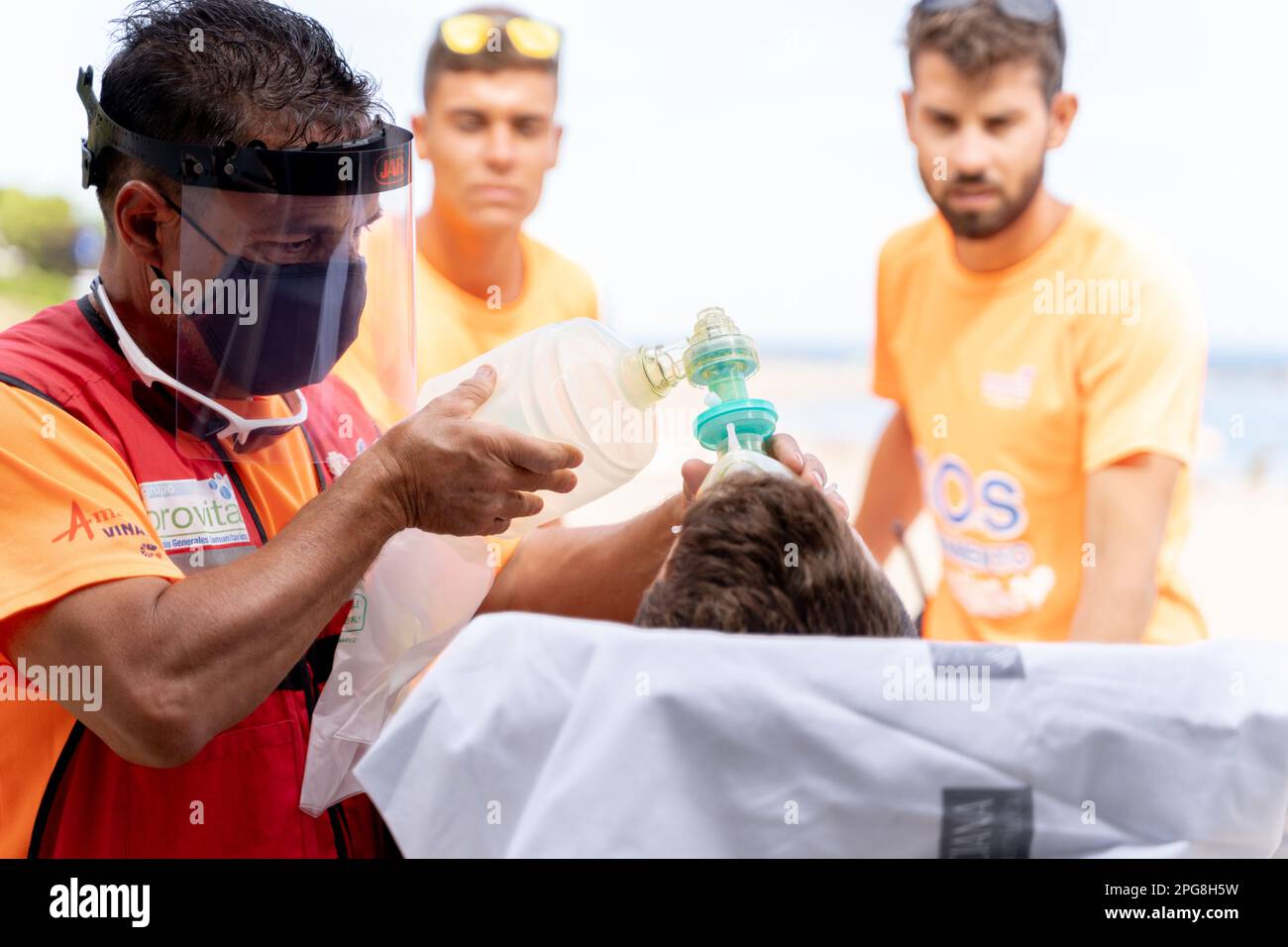 Close up view of a patient receiving oxygen from lifeguards on the ...