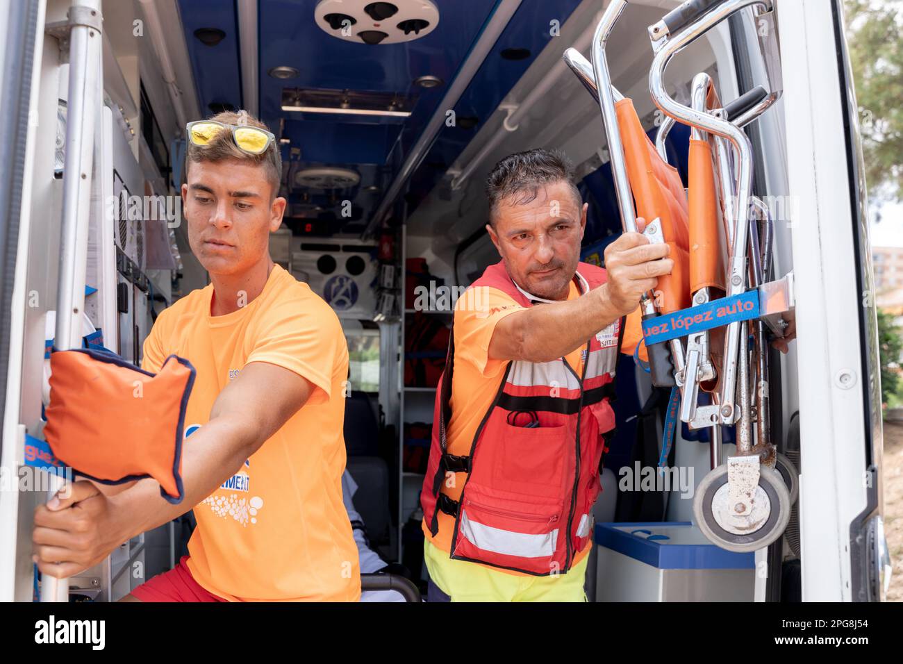 Lifeguards team on a duty closing the doors of an ambulance Stock Photo ...