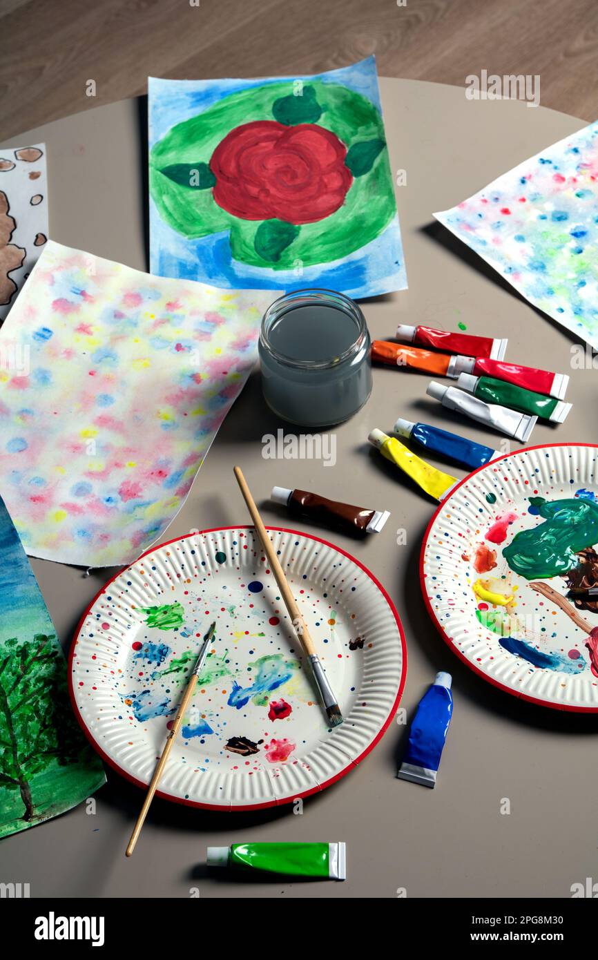 photo a lot of paints in a tube, sheets for painting, brushes on a ...