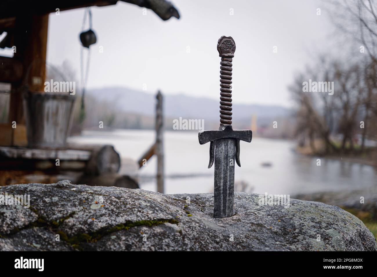 famous sword excalibur of King Arthur stuck in the rock. Edged weapons ...