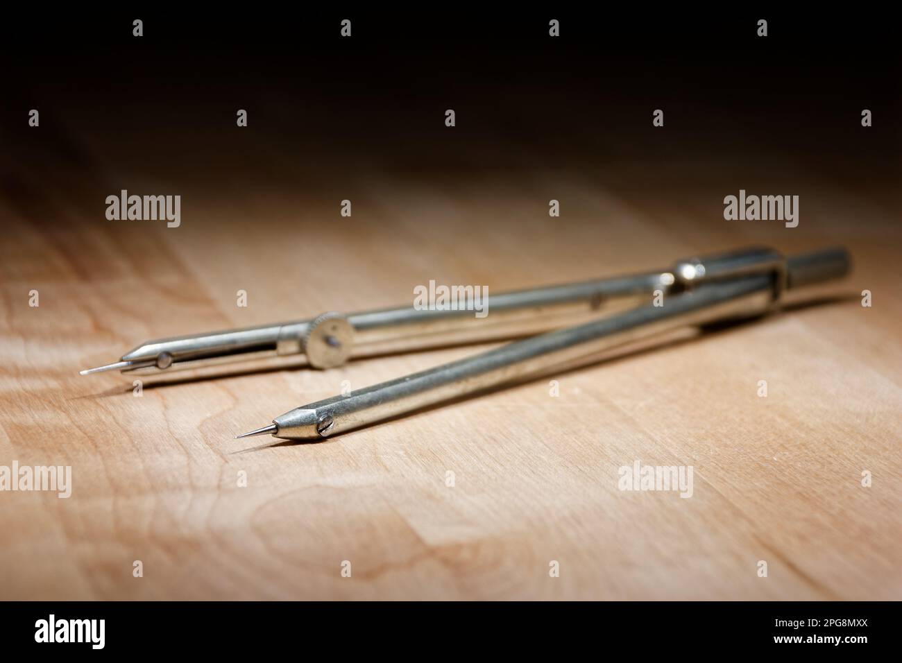 divider. compass for geometric construction lying on wooden table Stock ...