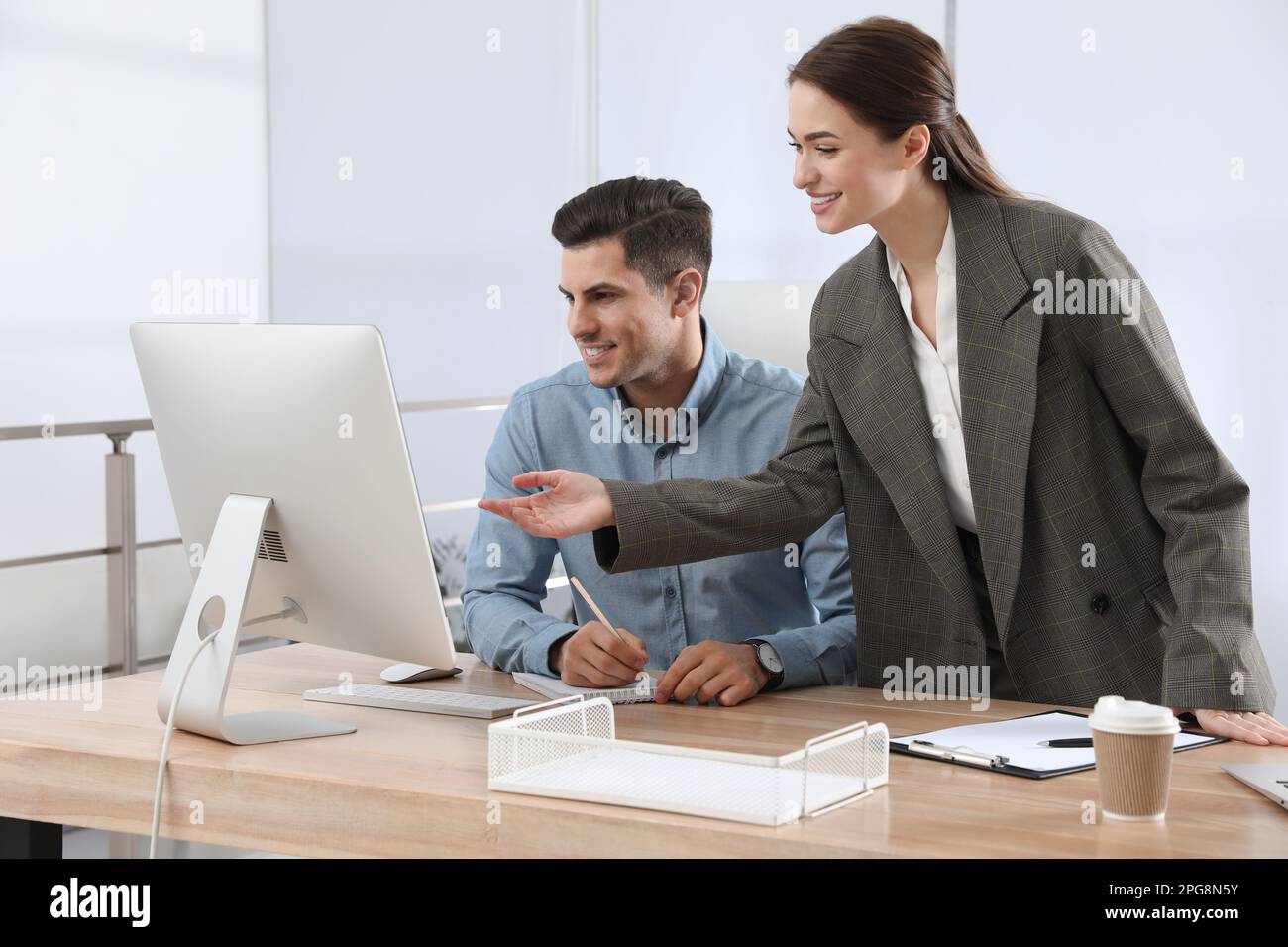 Female office worker helping male hi-res stock photography and images ...