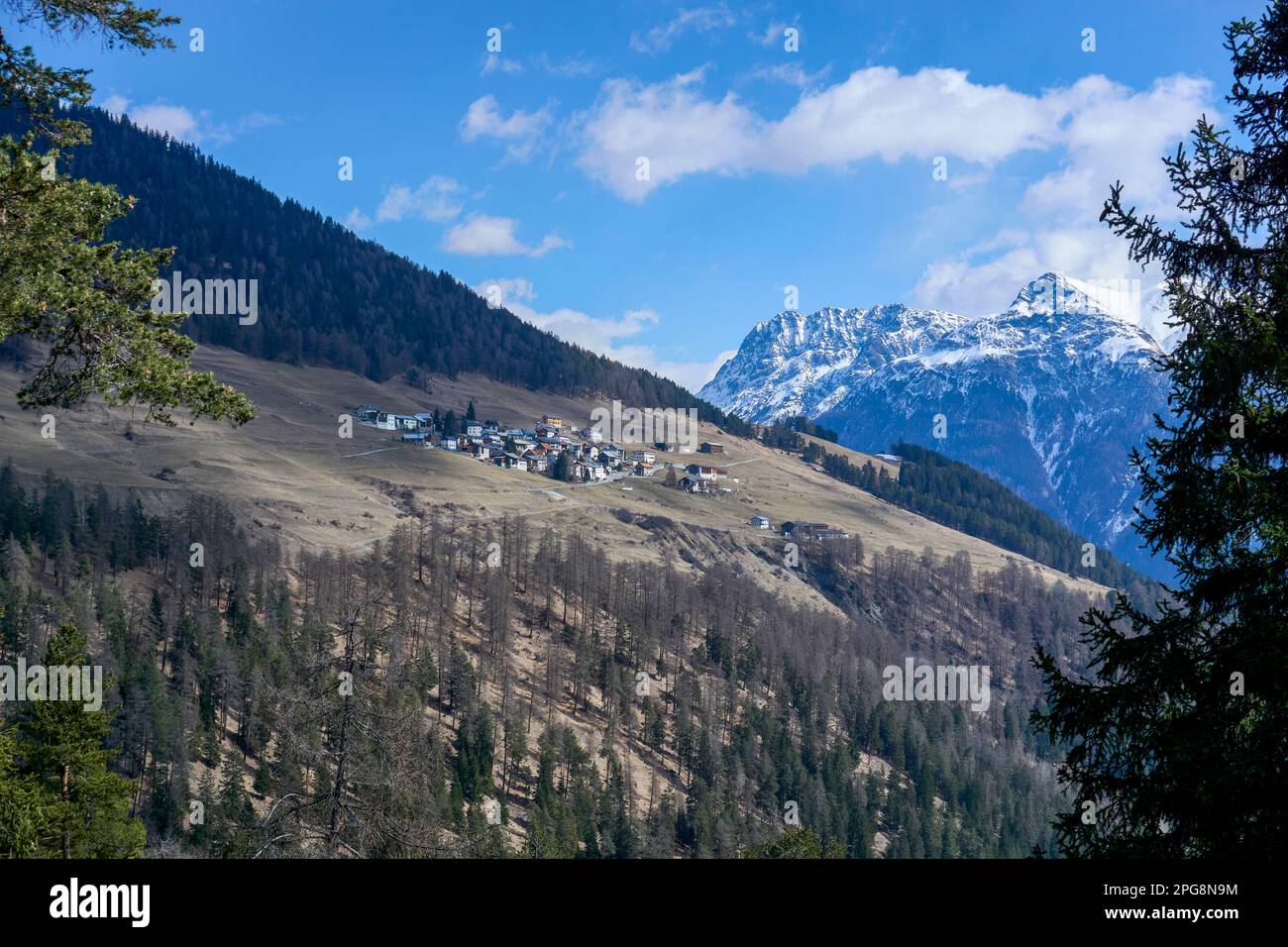 The small village of Vnà (1,602 m) on the foothills of Piz Arina, with ...