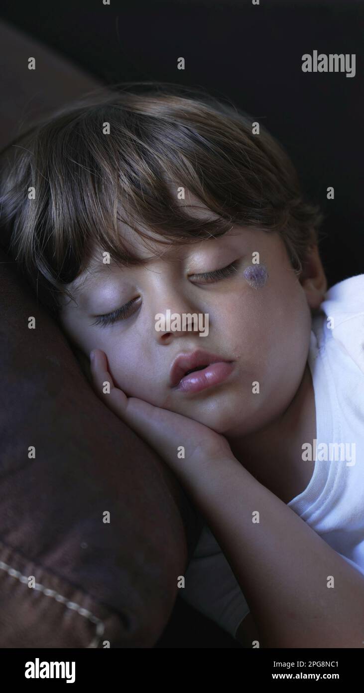 One little boy sleeping on couch. Child asleep napping on sofa portrait ...