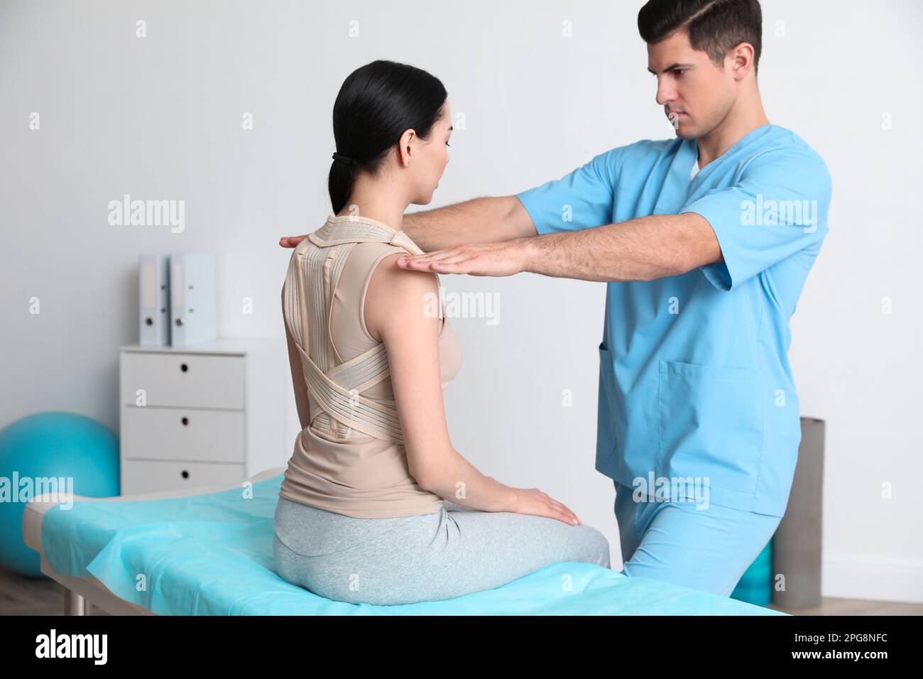 Orthopedist examining woman in clinic. Scoliosis treatment Stock Photo ...