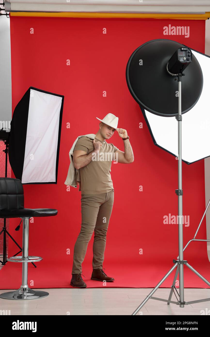 Handsome model posing in studio. Professional photo session Stock Photo ...