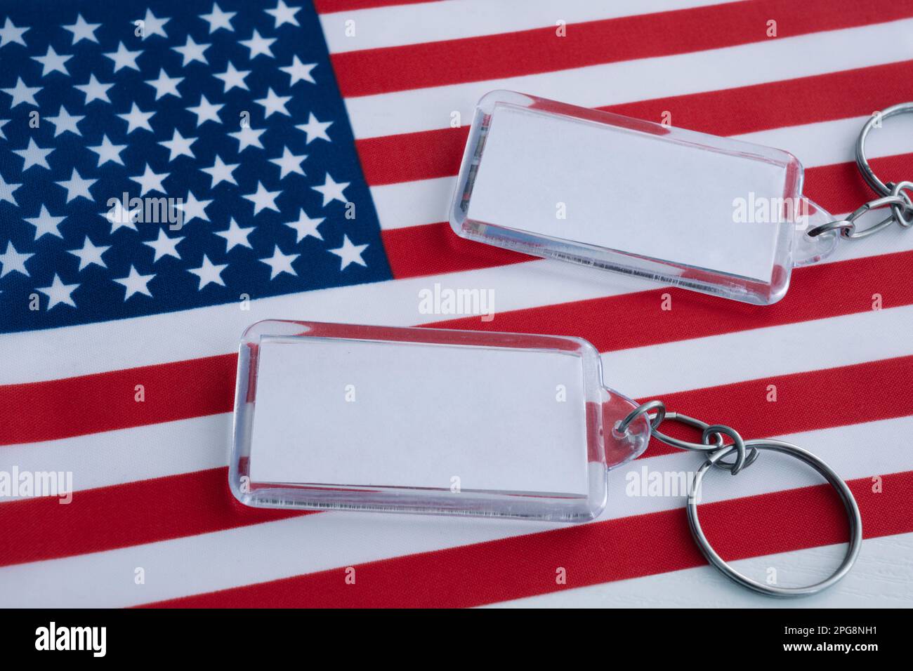 a shiny keychain with a white label for text on the background of the ...