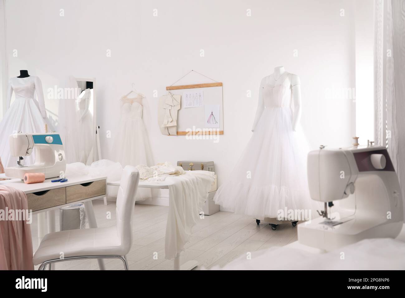Dressmaking workshop interior with wedding dresses and equipment Stock ...
