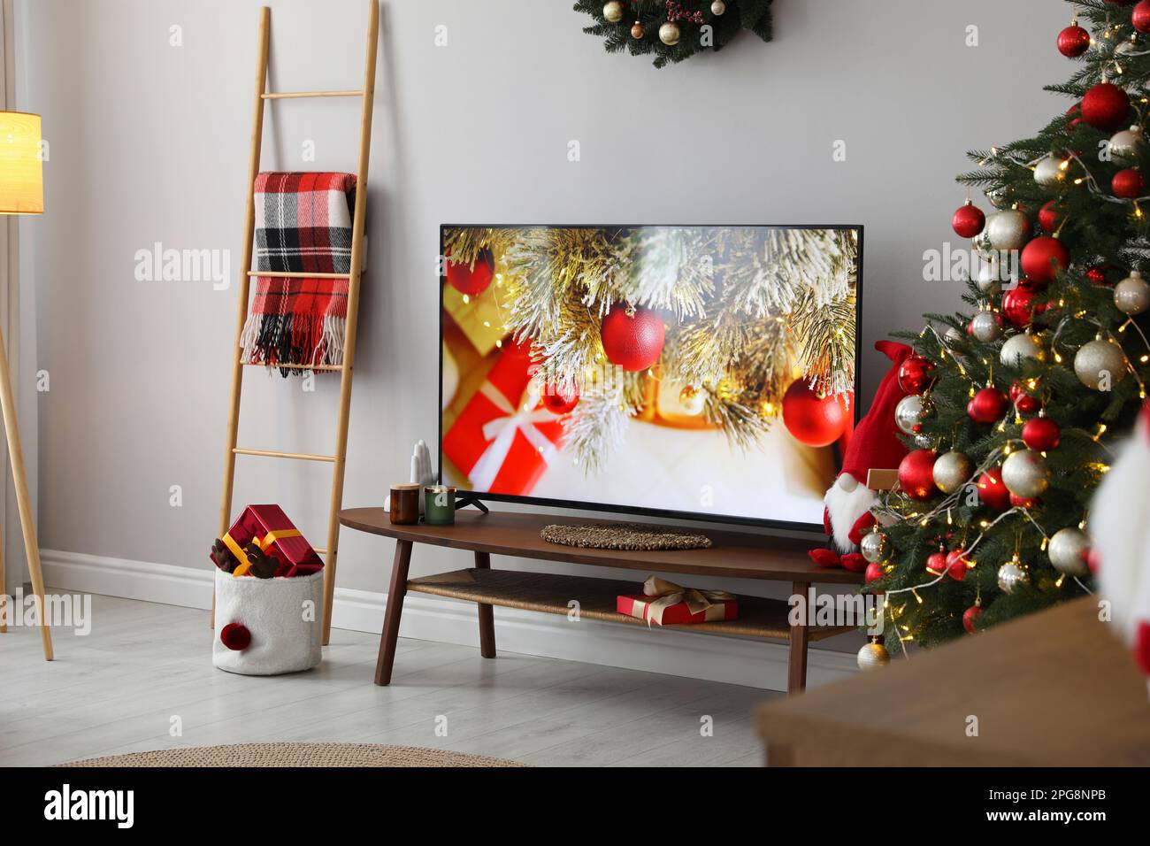 Stylish living room interior with modern TV and Christmas tree Stock ...