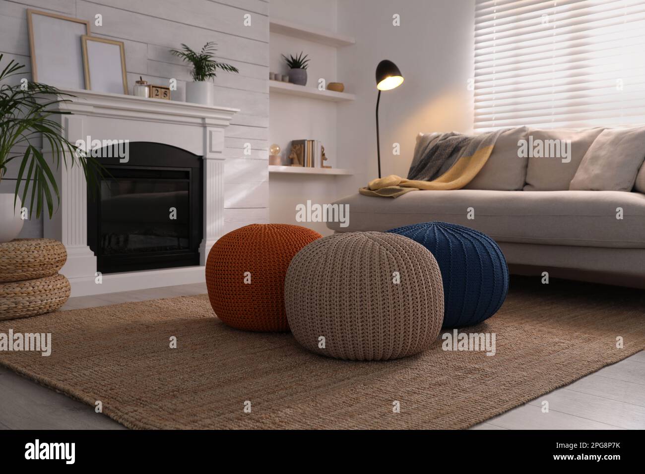 Stylish comfortable poufs near sofa in room. Home design Stock Photo ...