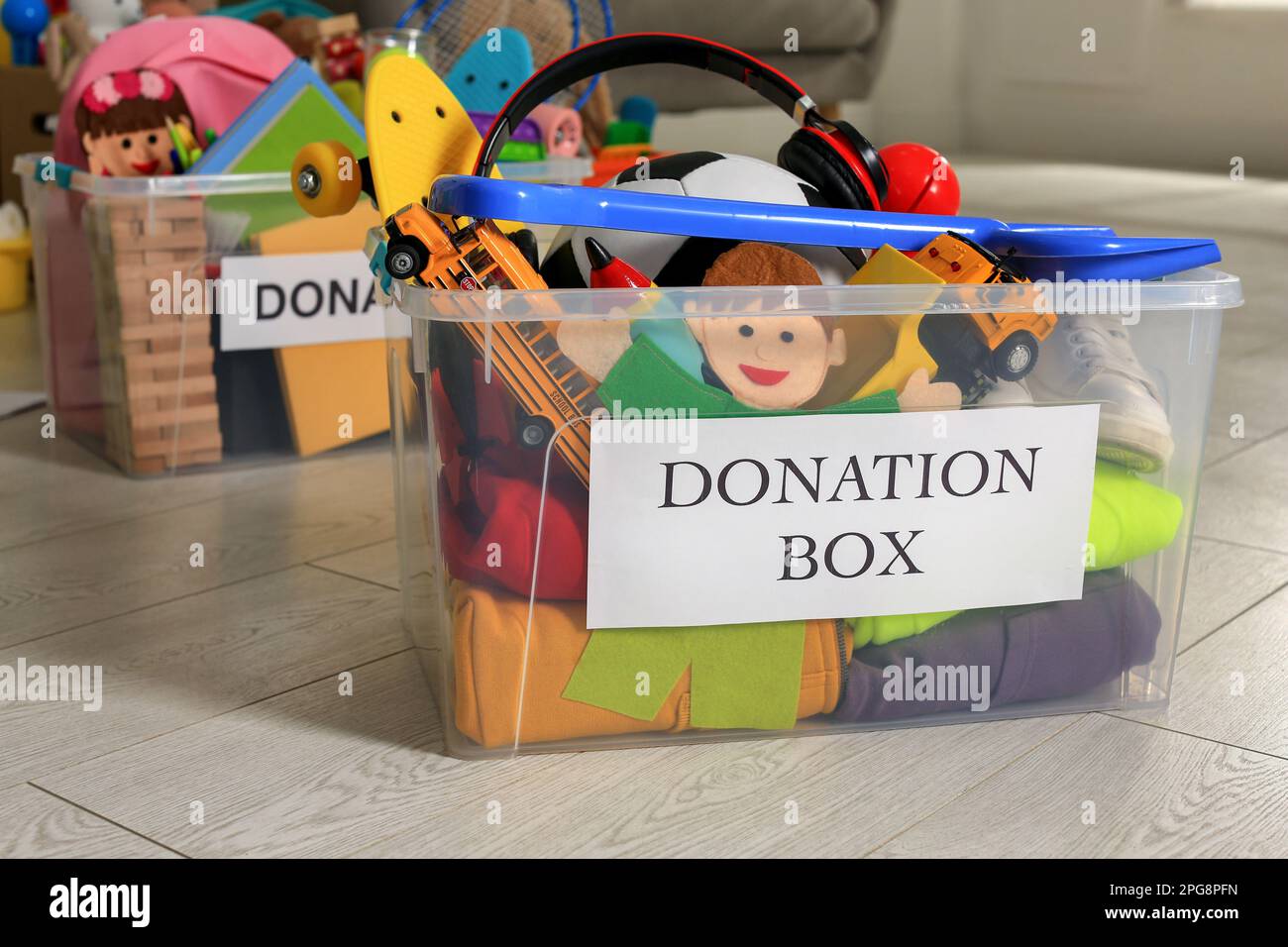 Donation boxes with different child toys on floor indoors Stock Photo ...