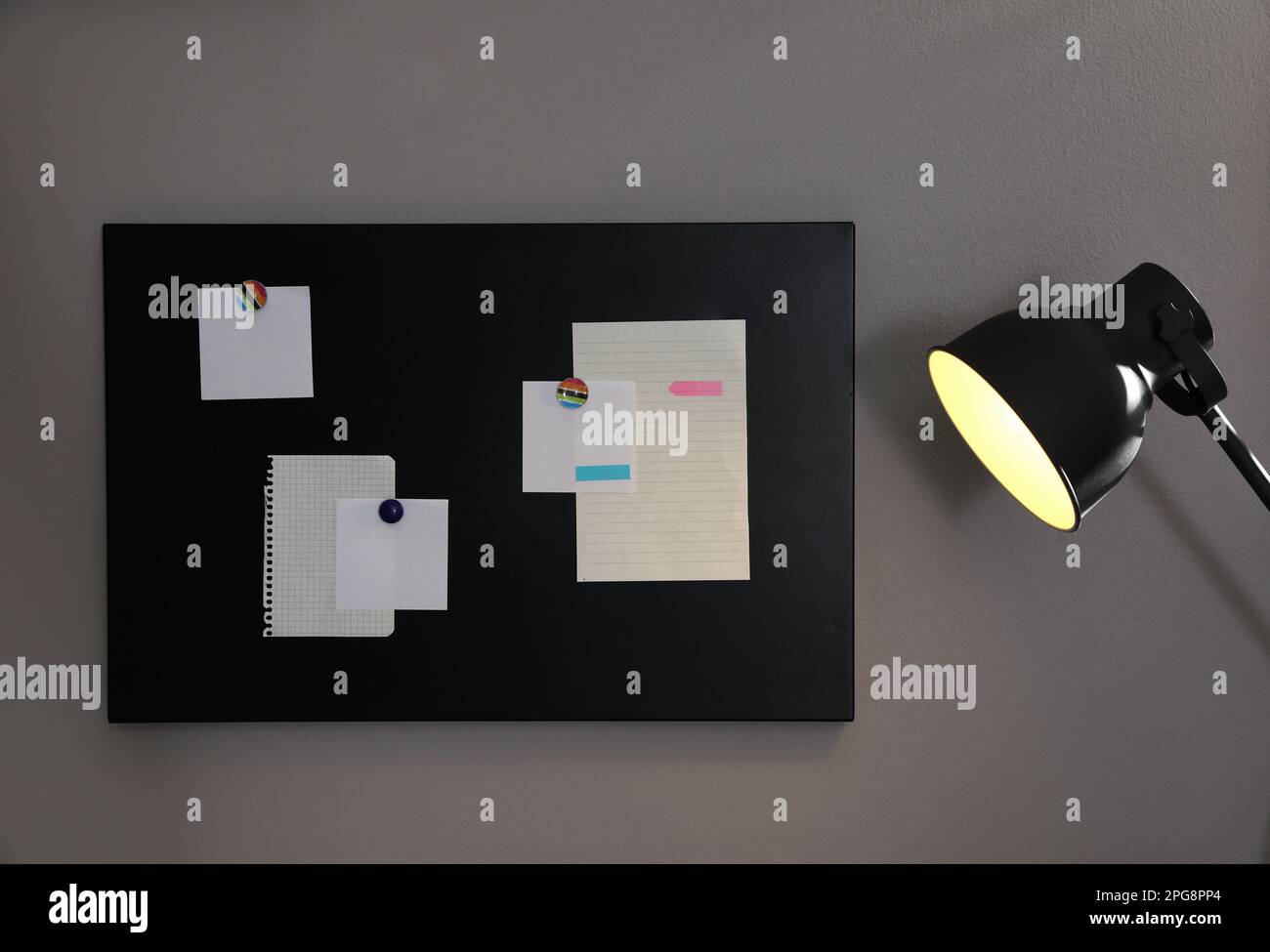 Many notes attached to magnetic black board on grey wall Stock Photo ...