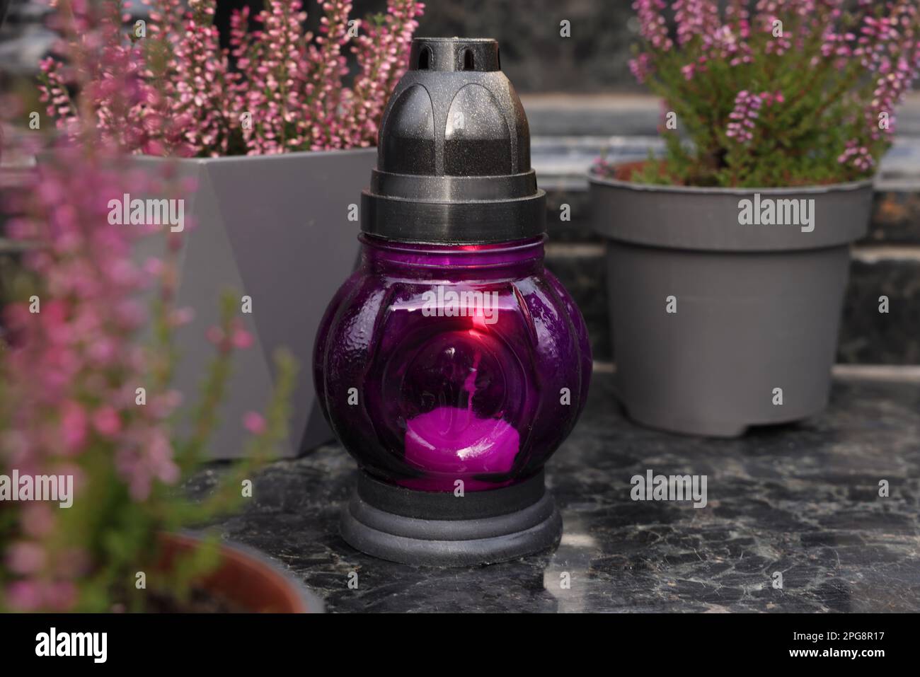 Grave lantern on grey granite surface at cemetery Stock Photo - Alamy