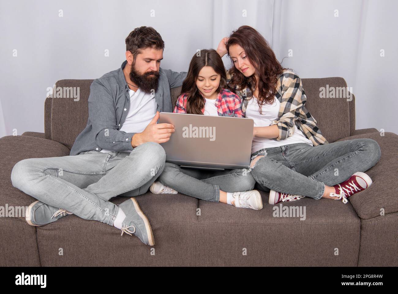family blog. happy parents with kid girl study online. curious mom dad ...