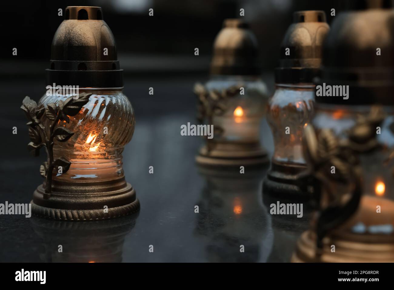 Grave lights on granite surface at cemetery Stock Photo - Alamy