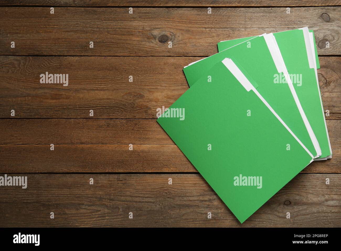 Light green files with documents on wooden table, top view. Space for ...