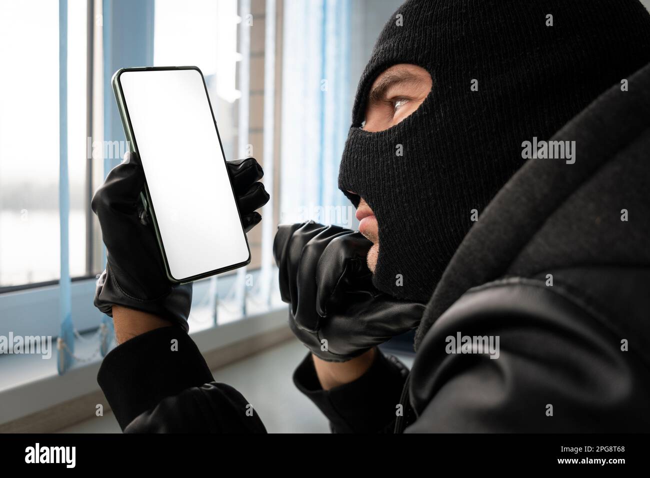 Young adult in black clothes with hidden face. Ill-intended fraudster ...