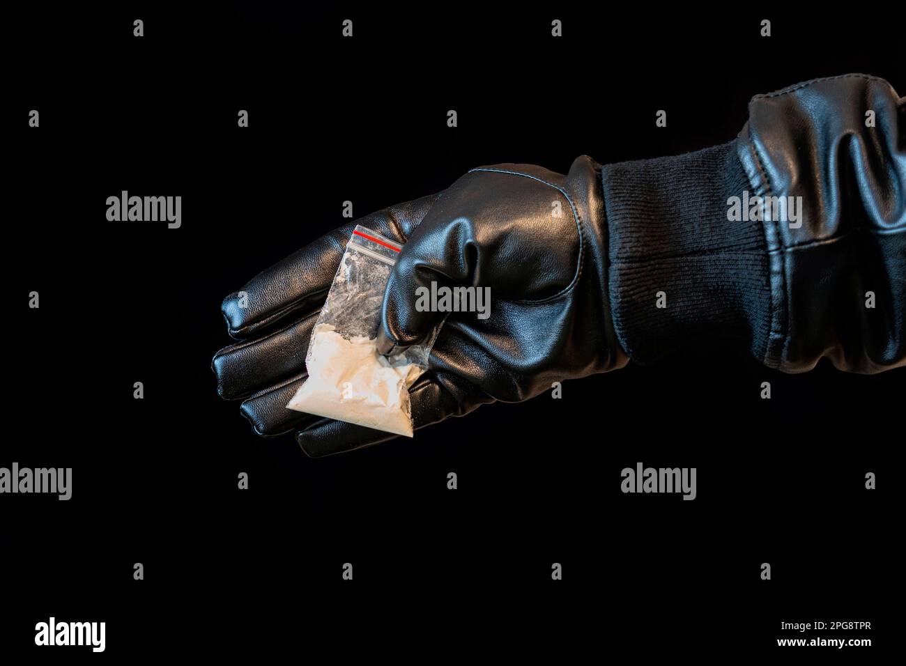 Mans hand holding on palm plastic packet with cocaine powder or another ...