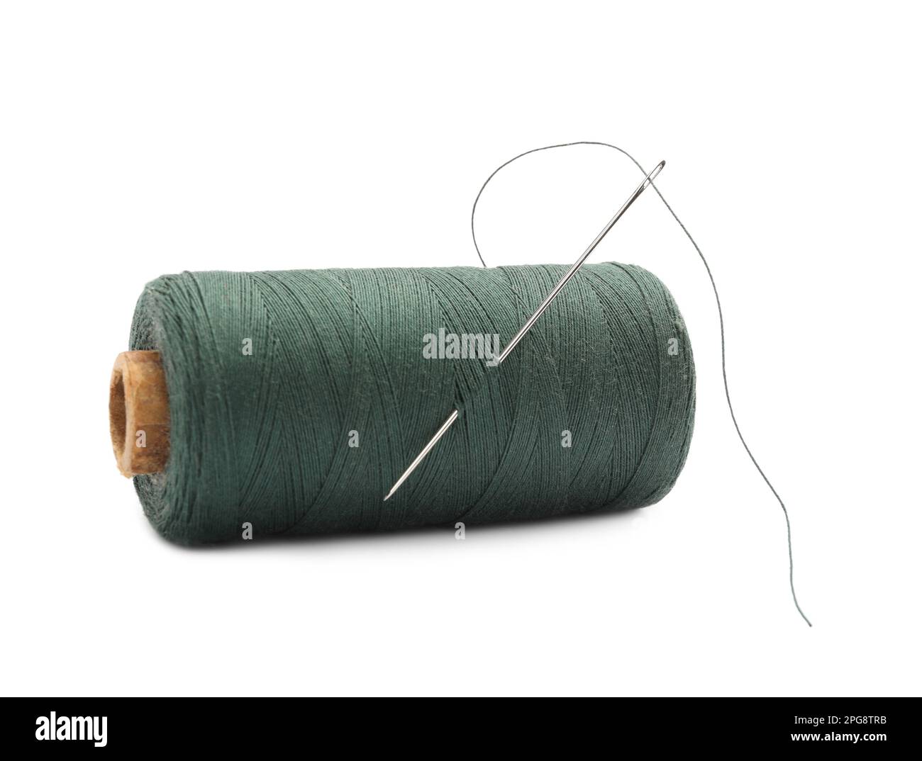 Green sewing thread with needle on white background Stock Photo - Alamy