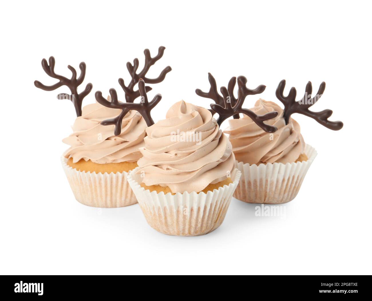 Delicious Christmas cupcakes with chocolate reindeer antlers on white ...