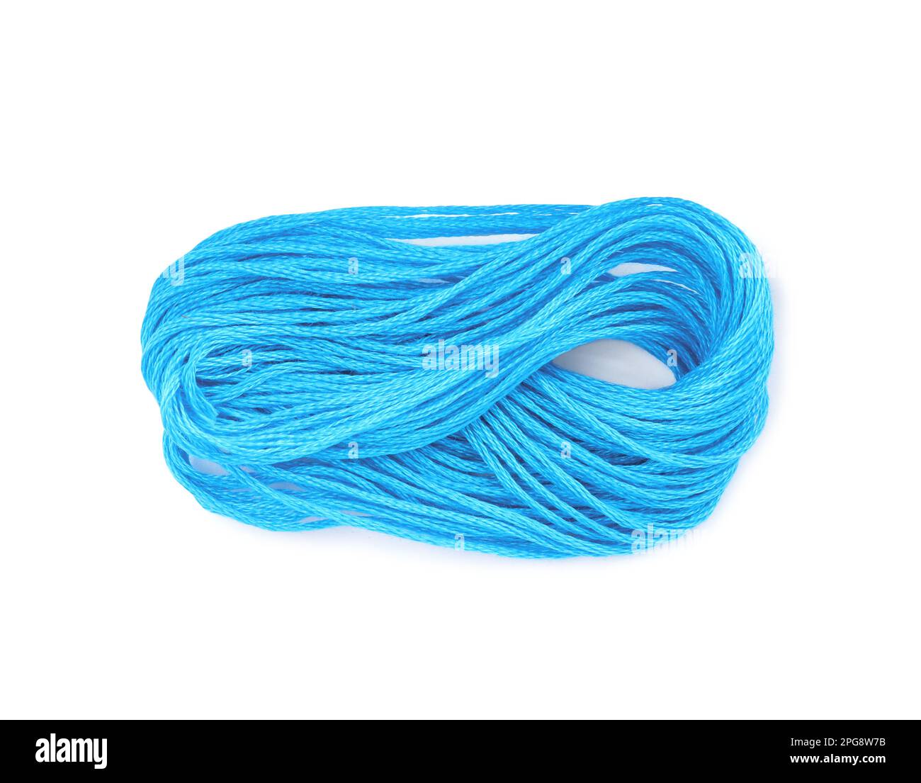 Light blue embroidery thread on white background Stock Photo - Alamy