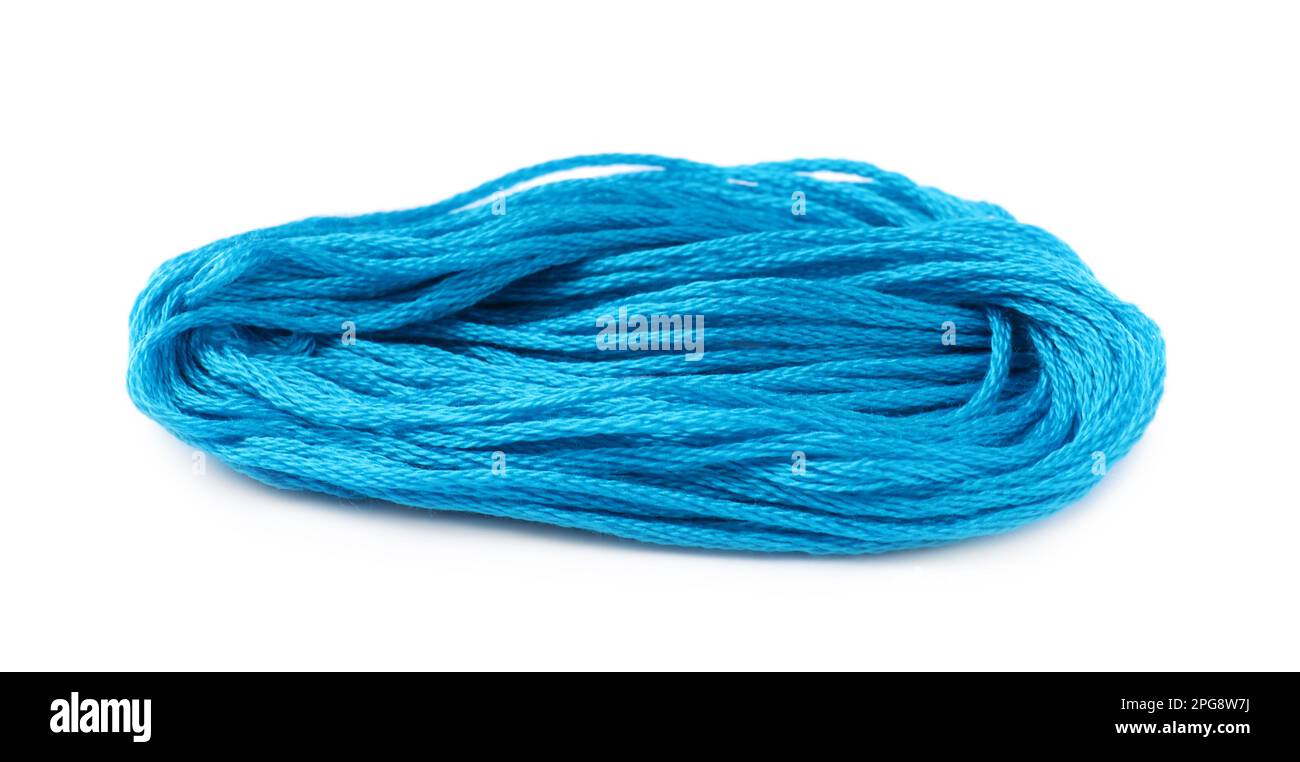 Light blue embroidery thread on white background Stock Photo - Alamy
