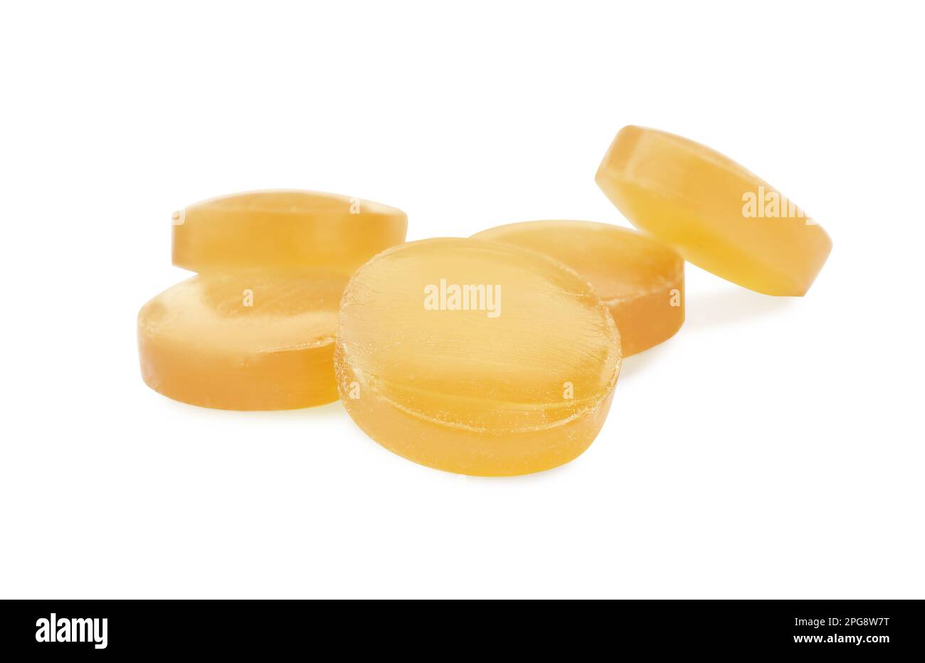 Many yellow cough drops on white background Stock Photo - Alamy