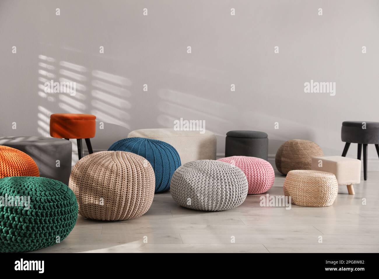 Many stylish different poufs indoors. Home design Stock Photo - Alamy