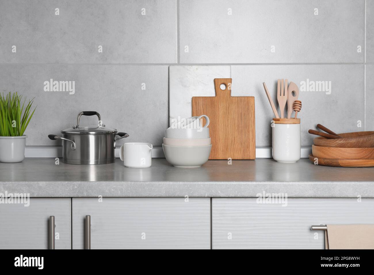 Cooking utensils and other kitchenware on grey countertop Stock Photo ...