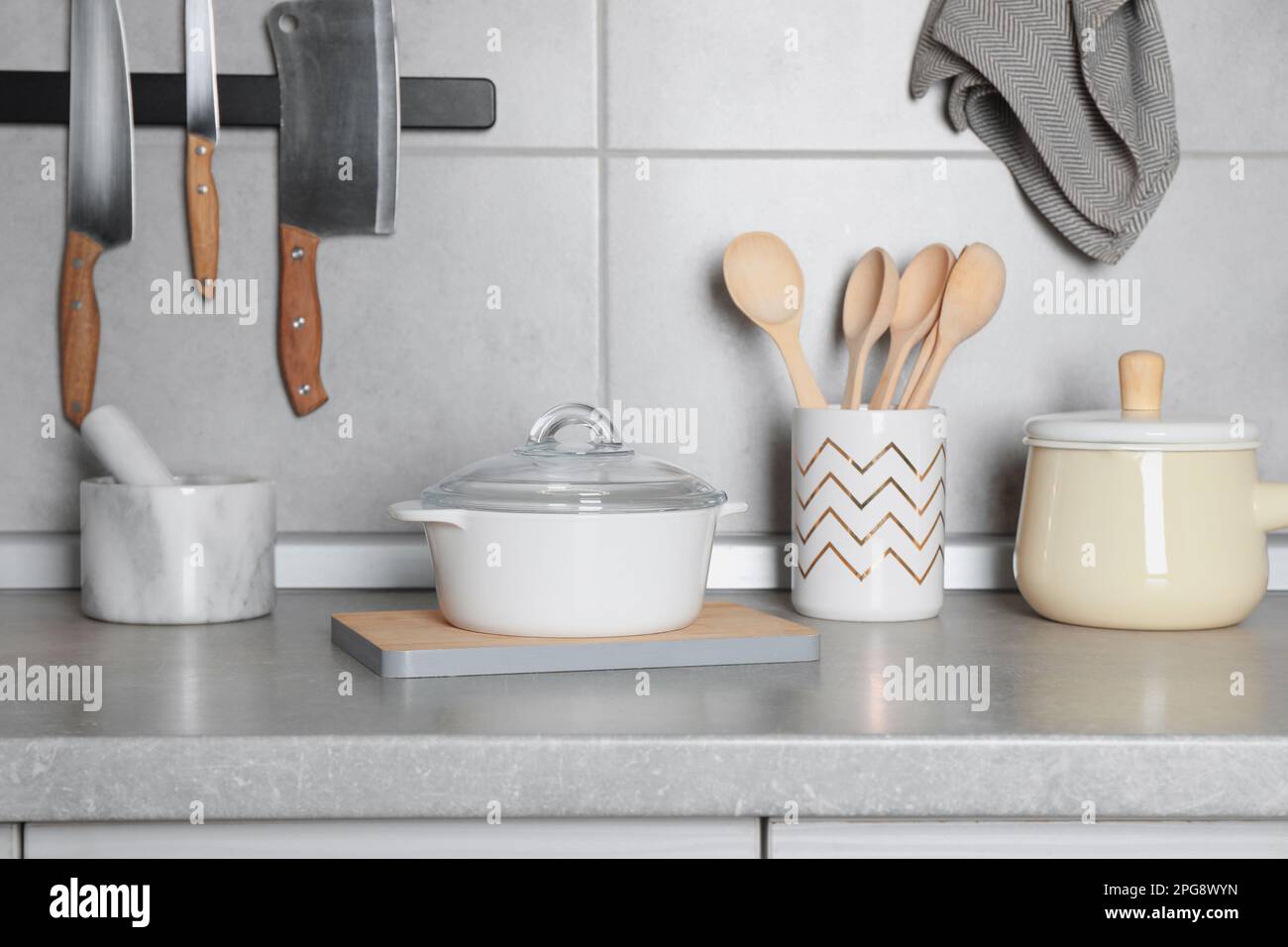 Set of cooking utensils and cookware on grey countertop Stock Photo - Alamy