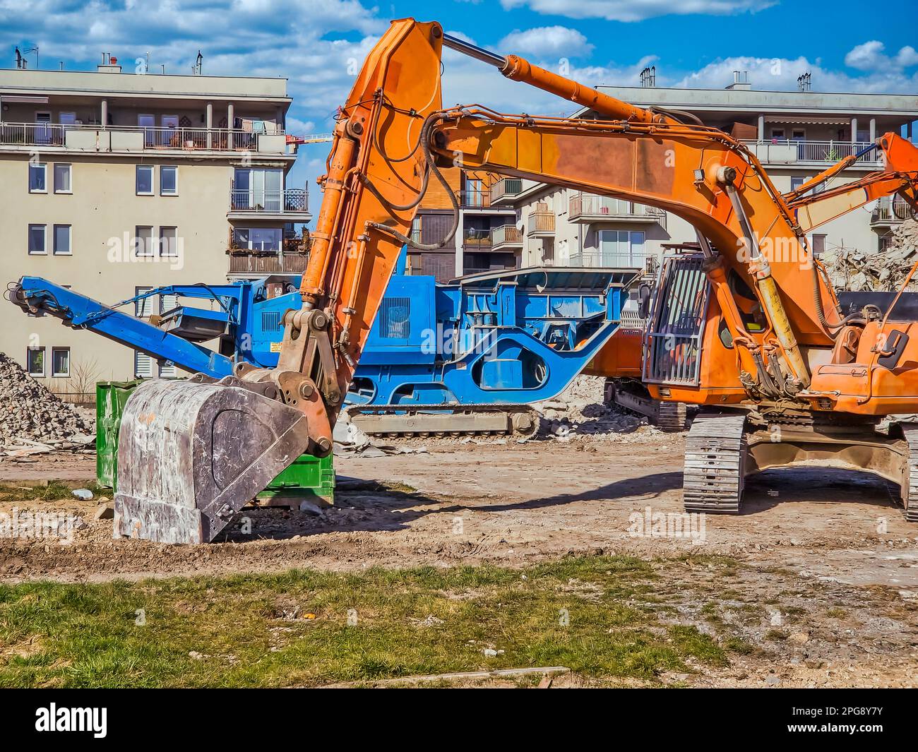 Orange excavator on the construction site Stock Photo - Alamy