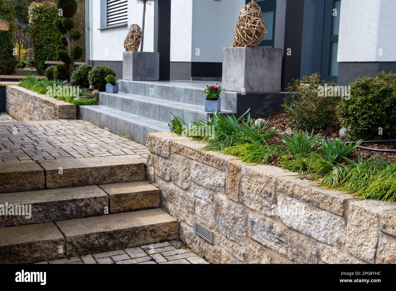 Well-maintained front garden with block steps made of natural stone and ...