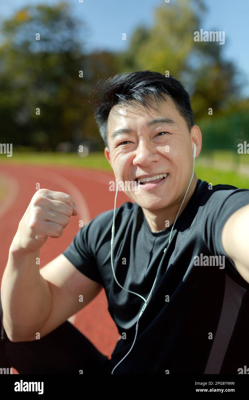 Close-up photo. Vertical photo. A young Asian sportsman man in ...