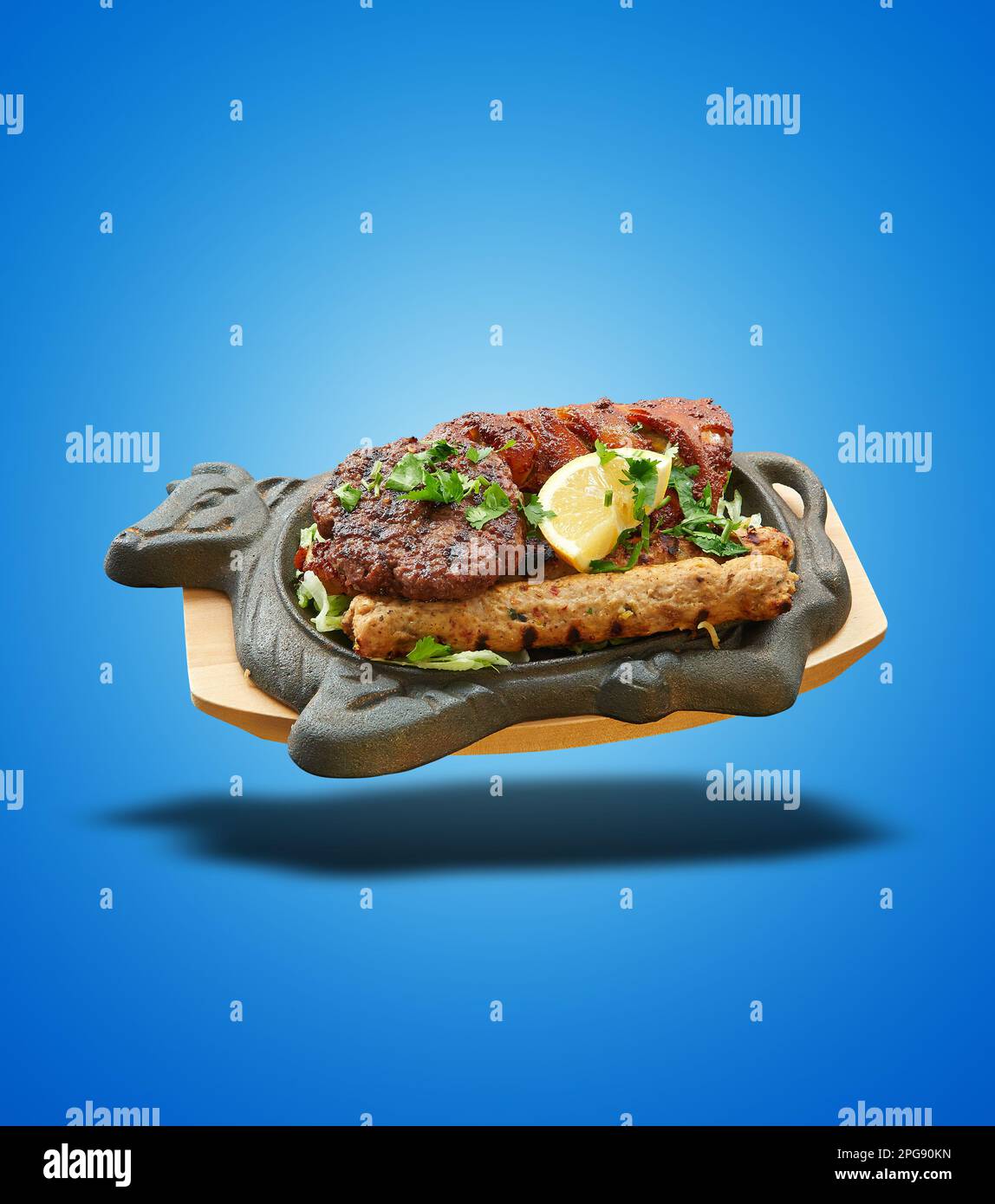 Floating Grilled Meal baked in little pan on blue gradient background ...
