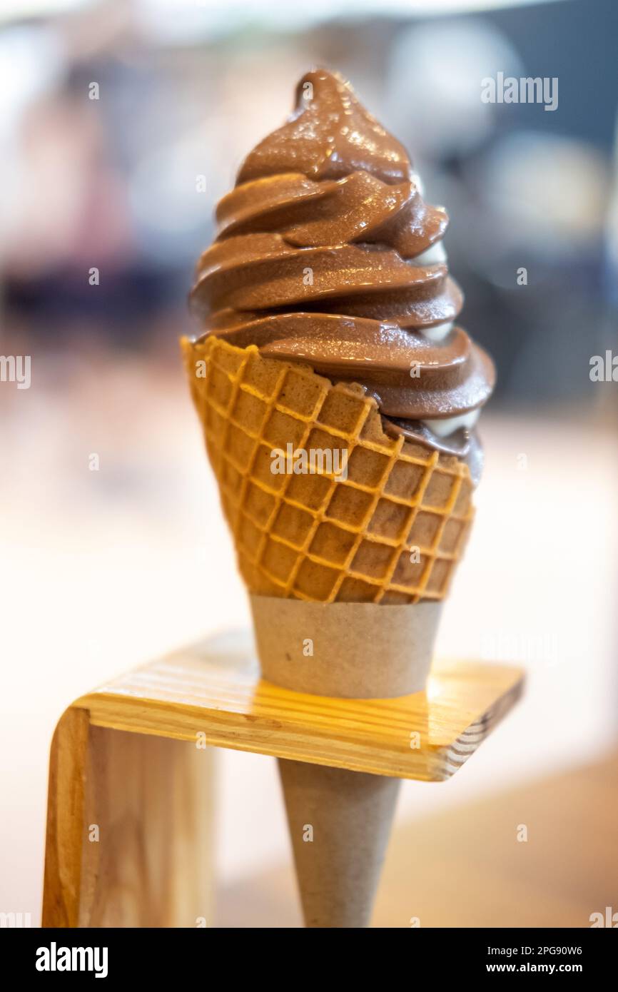 Chocolate Ice cream with waffle cone. blur background Stock Photo - Alamy