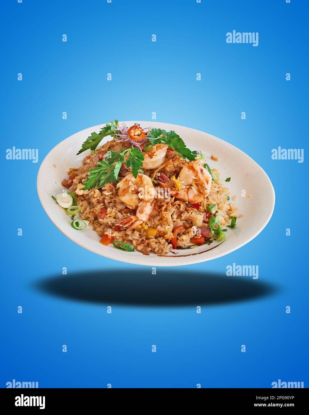 Floating Fried Rice and Shrimp on white Plate on blue gradient ...