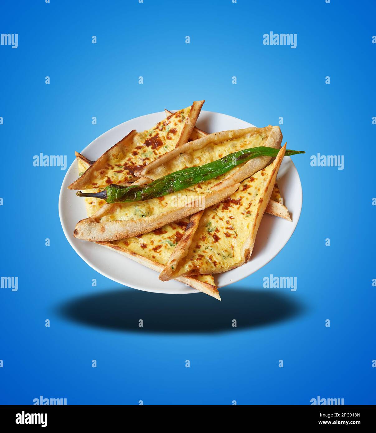 Floating Turkish Pide on Plate on blue gradient background Stock Photo ...