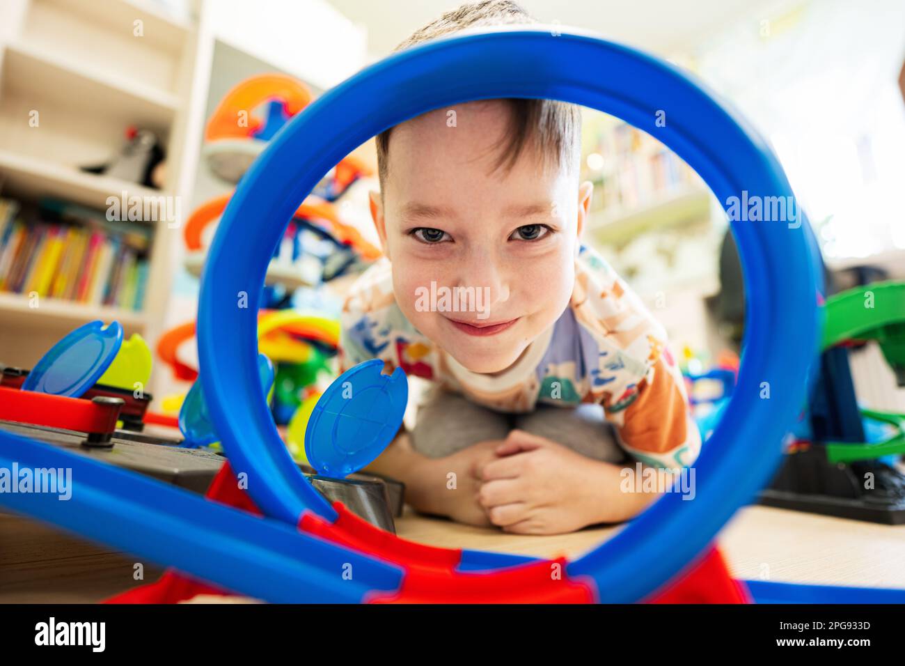 Kyiv, Ukraine - March, 2023: Boy play with collection of colorful toy ...