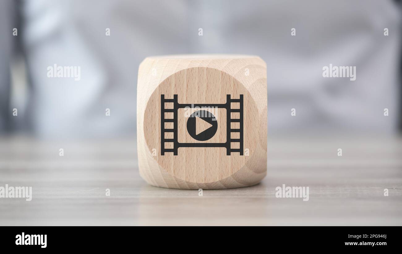 Wooden block with symbol of cinema concept Stock Photo - Alamy