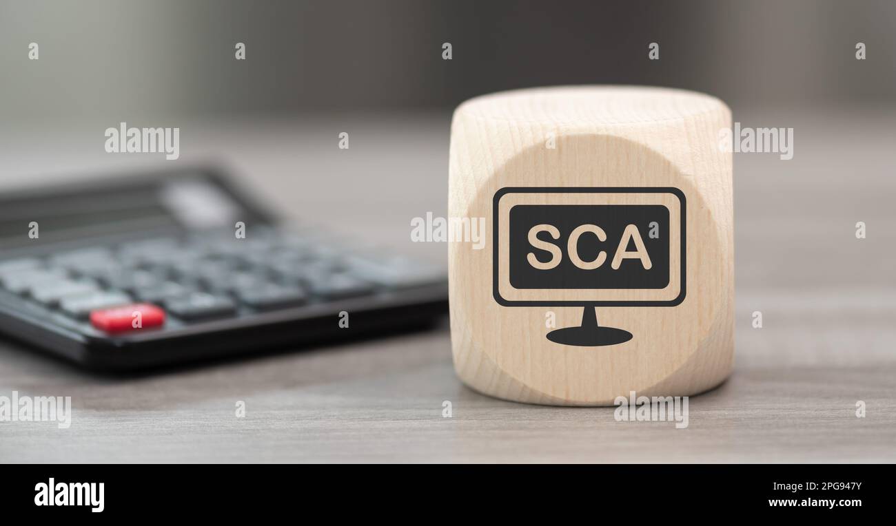 Wooden block with symbol of sca concept and calculator on background ...