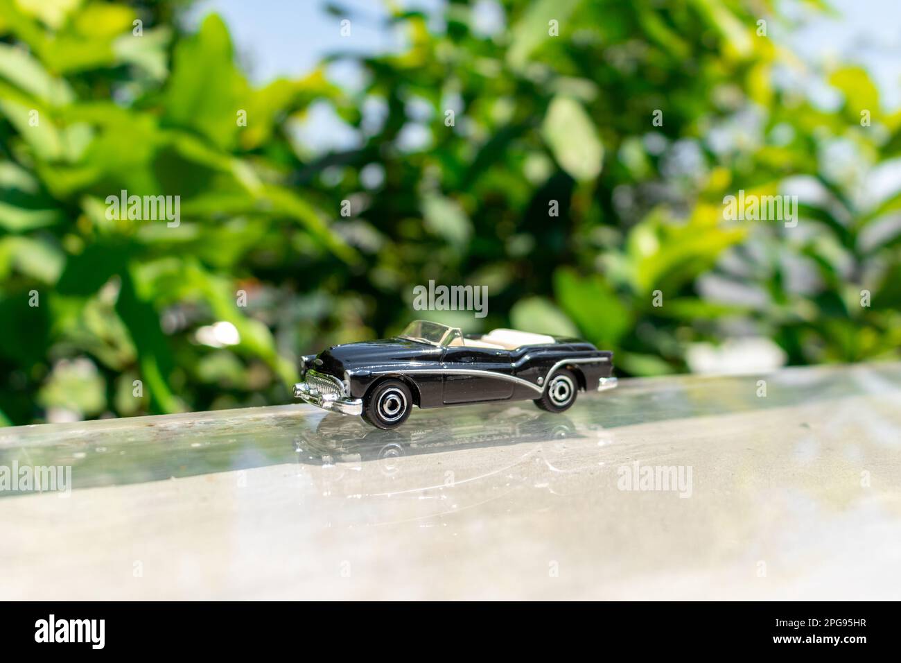 Concept for nature and adventure with a car. Black toy car placed at ...