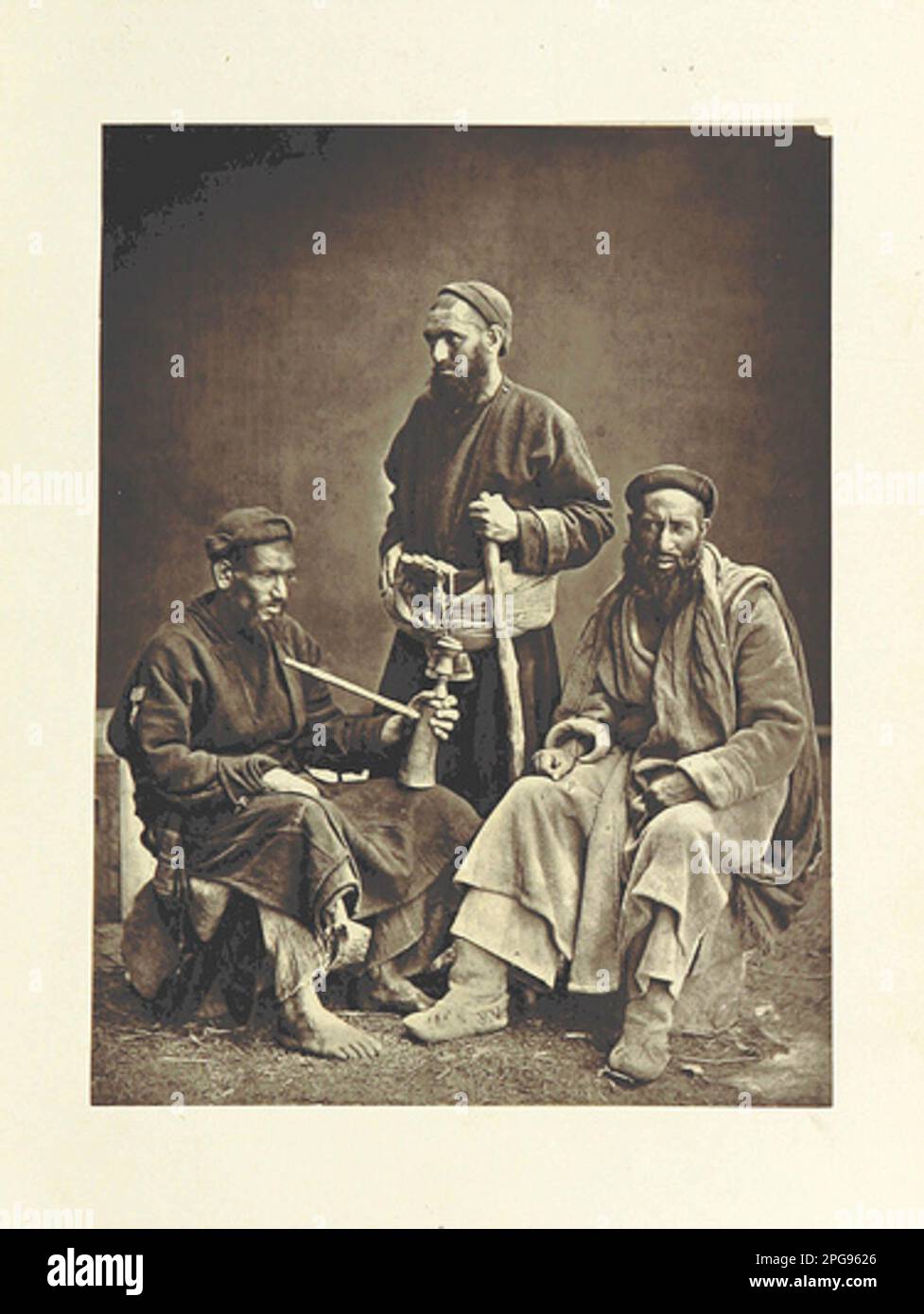 Men in Kashmiri phiran and poots, 1875 Stock Photo - Alamy