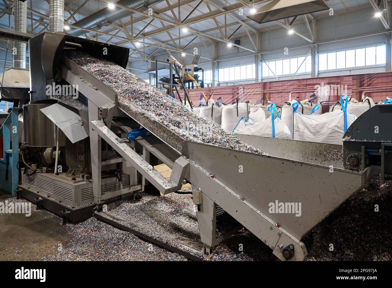 Chopped waste plastic transported by production line Stock Photo - Alamy