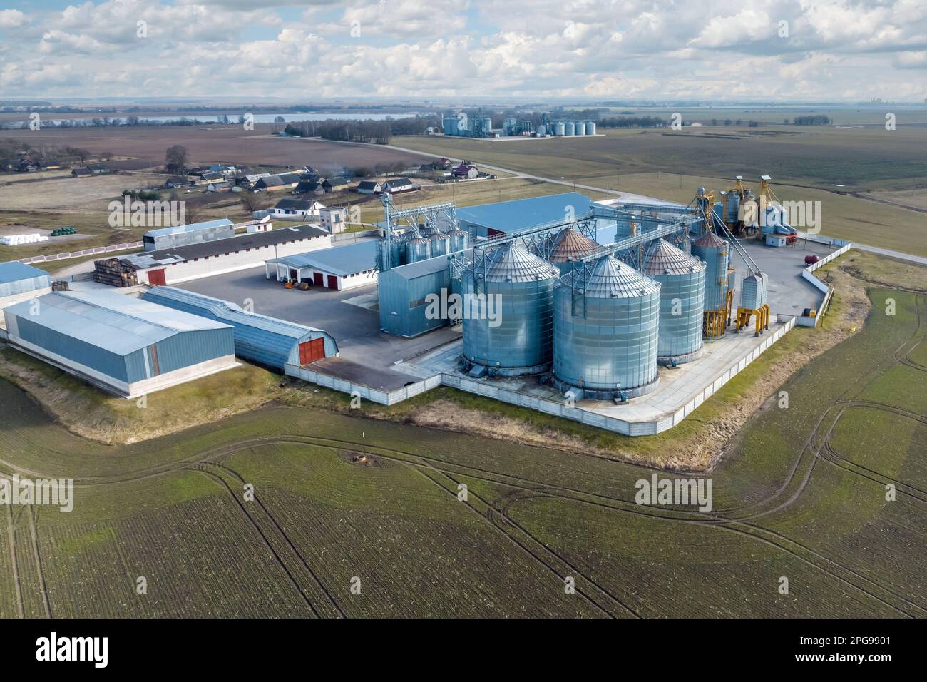 aerial view of agro-industrial complex with silos and grain drying line ...