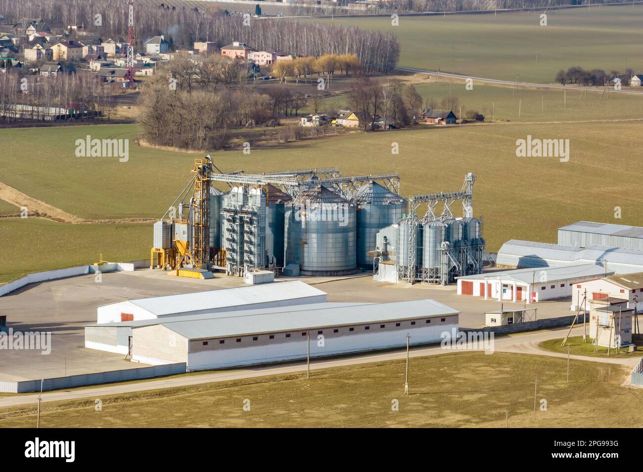 aerial view of agro-industrial complex with silos and grain drying line ...