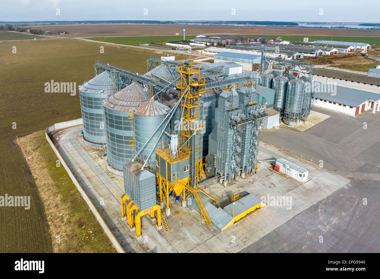 aerial view of agro-industrial complex with silos and grain drying line ...
